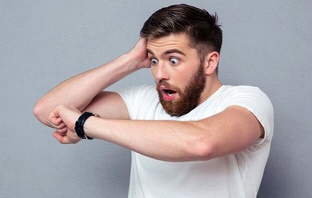Man Looking At His Watch Worried He Is Late - Careers & Internships